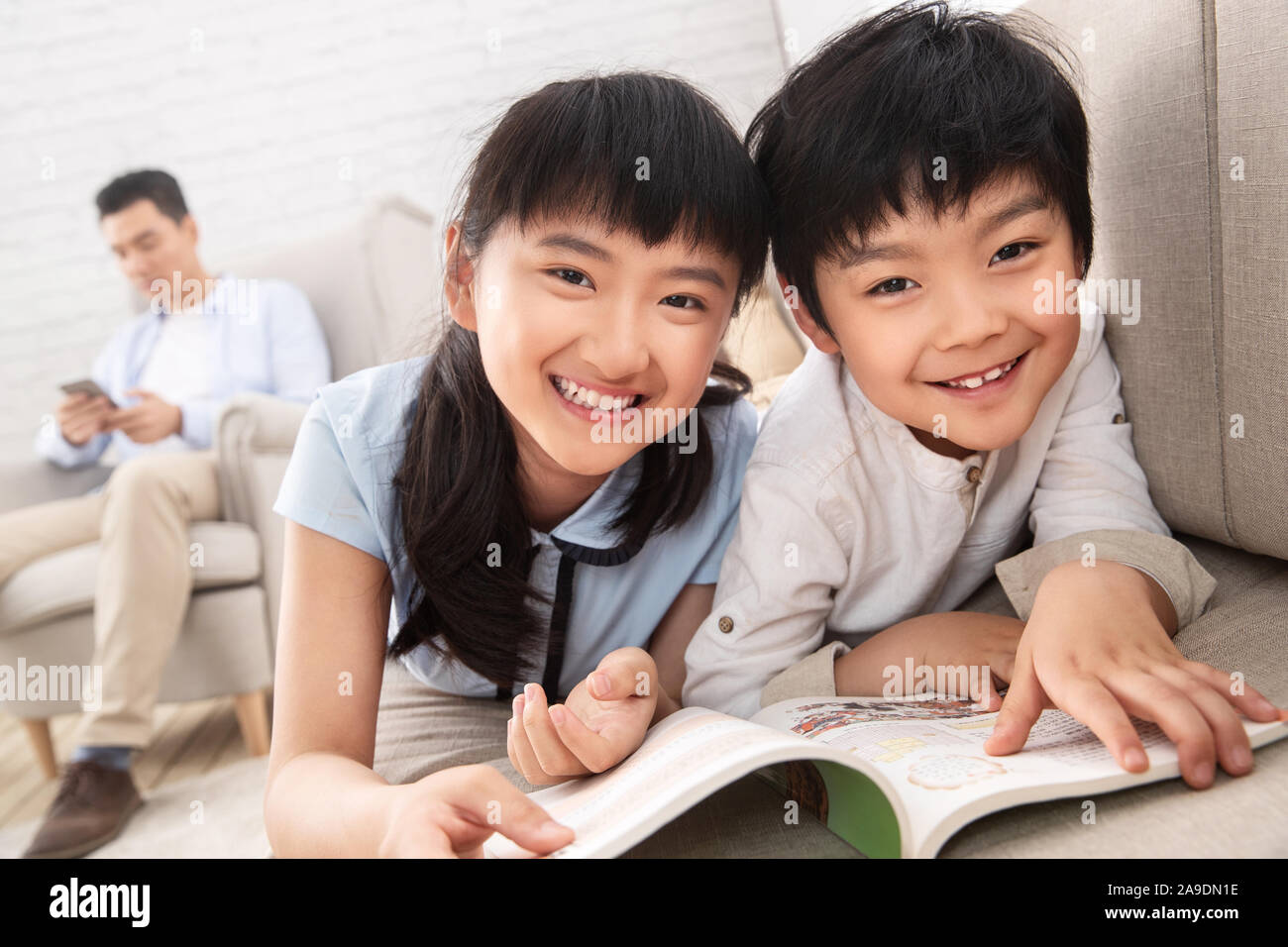 Siblings, two people reading Stock Photo - Alamy