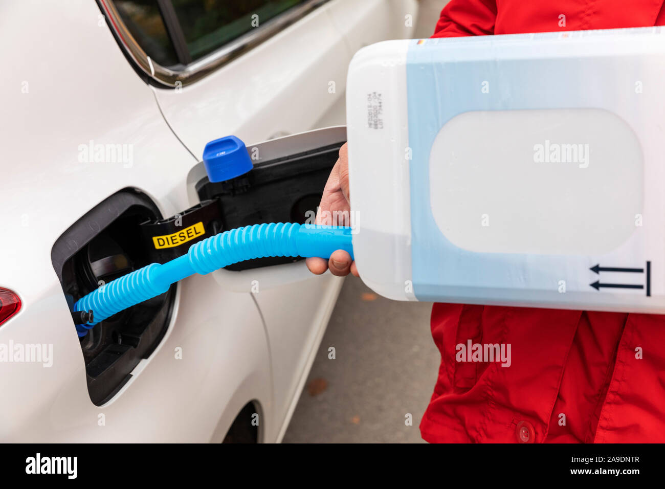 Refilling Ad Blue urea solution from 5 liter canisters, women's hands ...
