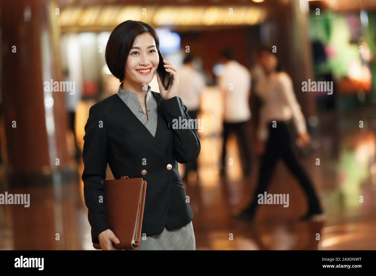 The hotel manager make a phone call Stock Photo - Alamy