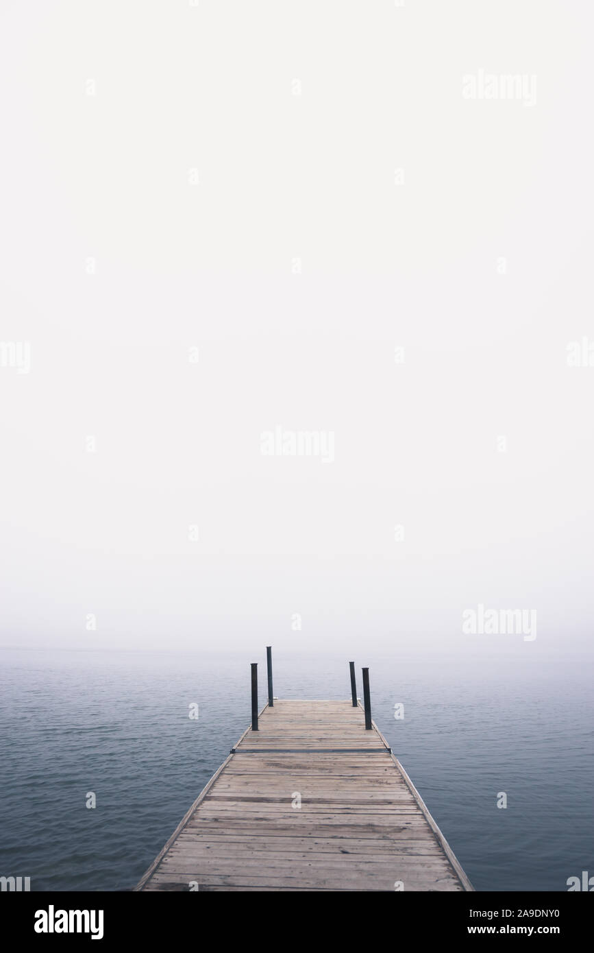 Dock on the lake in the fog during summer Stock Photo - Alamy