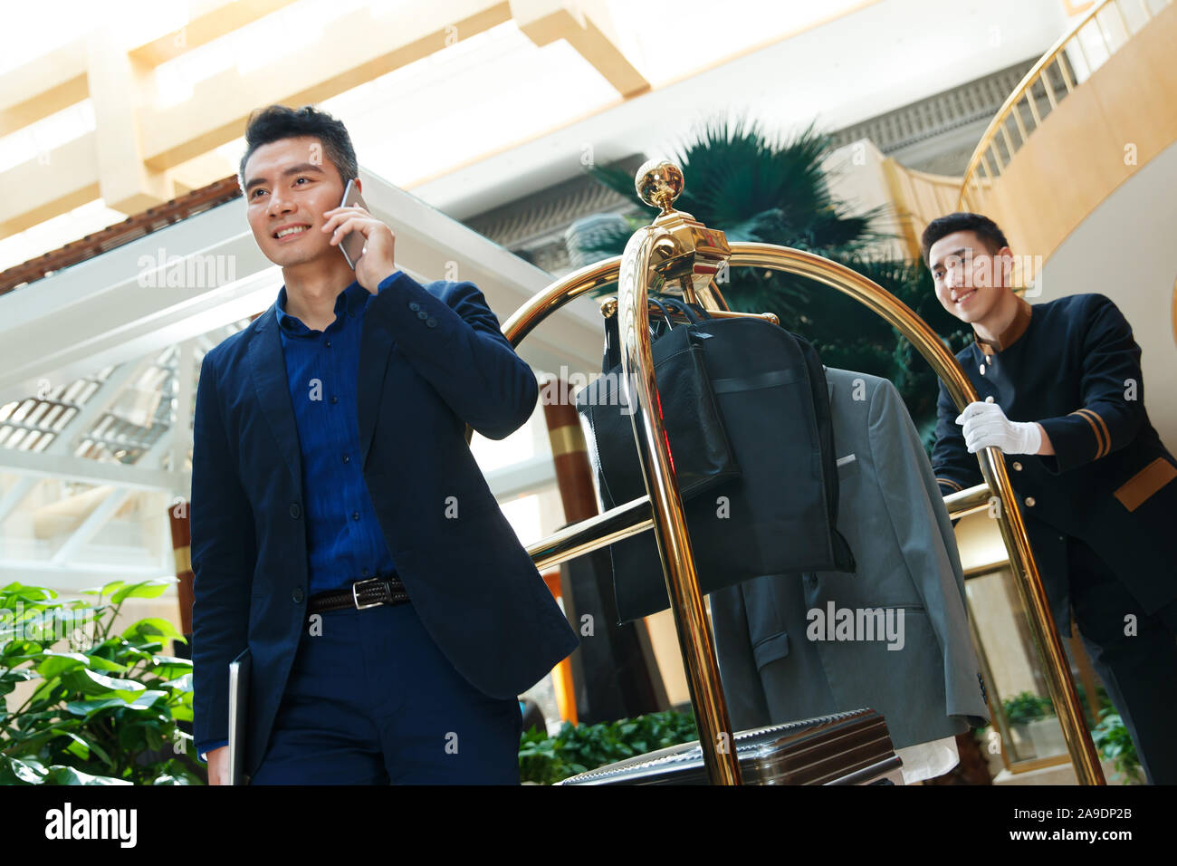 Business man make a phone call at the hotel lobby Stock Photo - Alamy