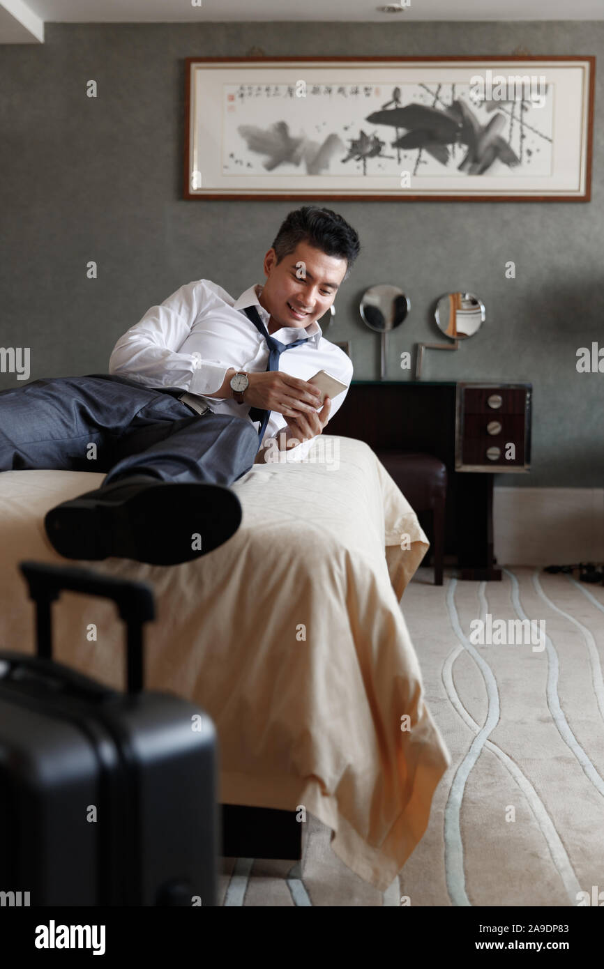 The young man in the hotel bed Stock Photo - Alamy