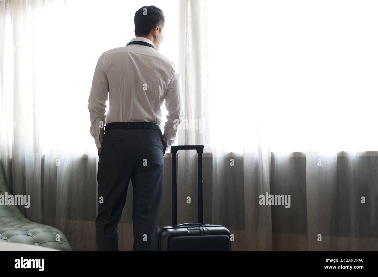 The young man standing in a hotel room Stock Photo - Alamy