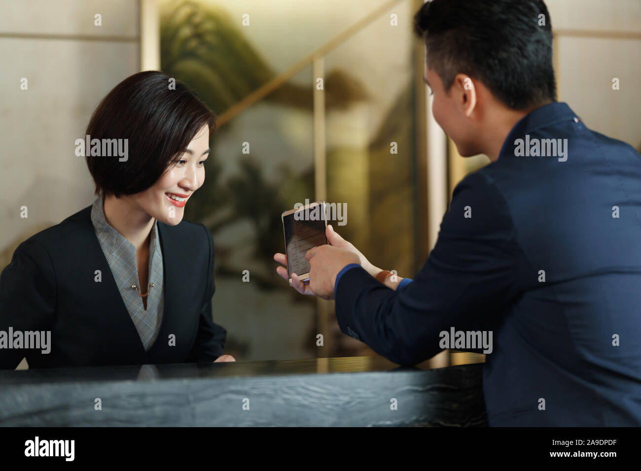 Business man for hotel registration Stock Photo - Alamy