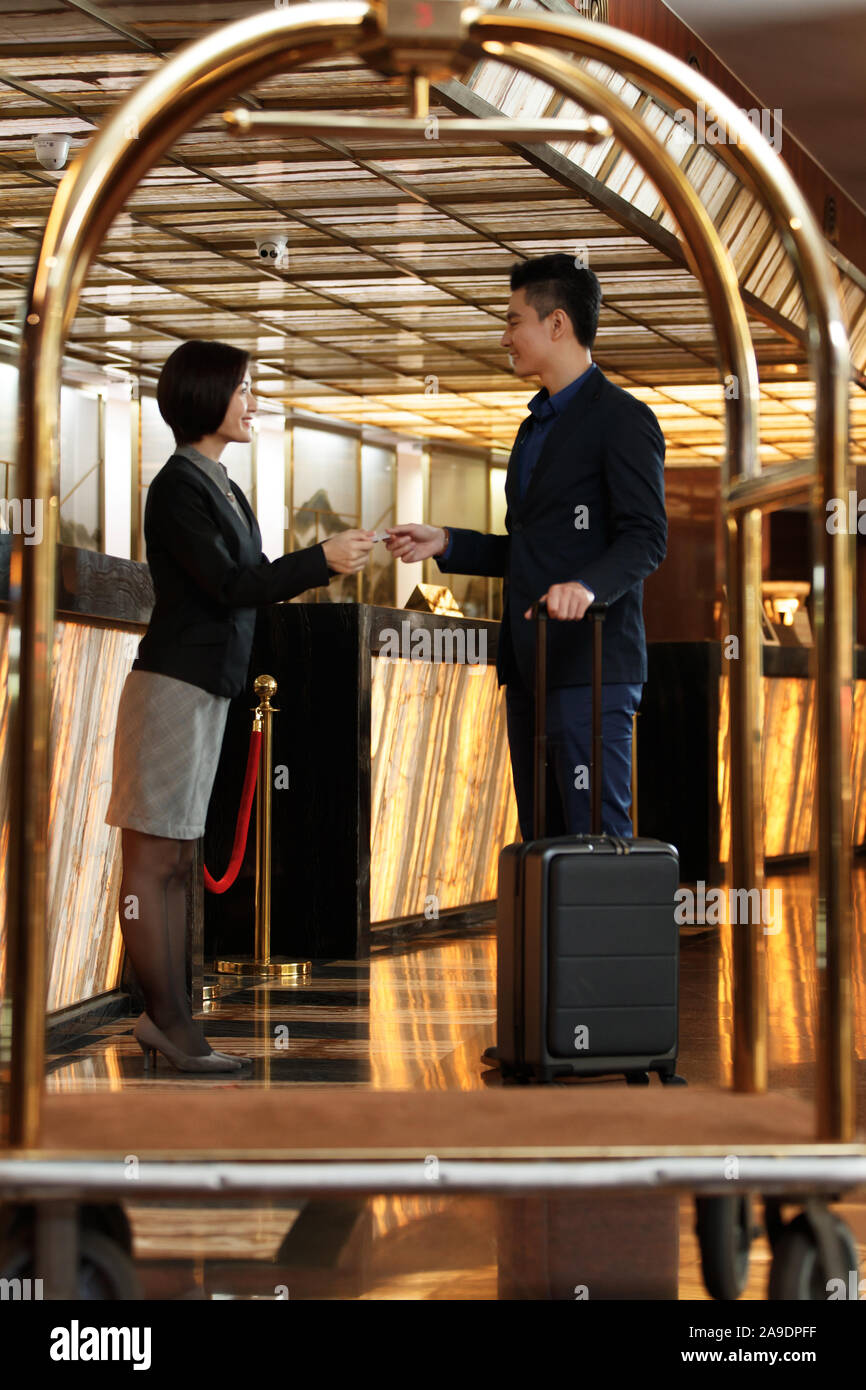 Business man for hotel registration Stock Photo - Alamy