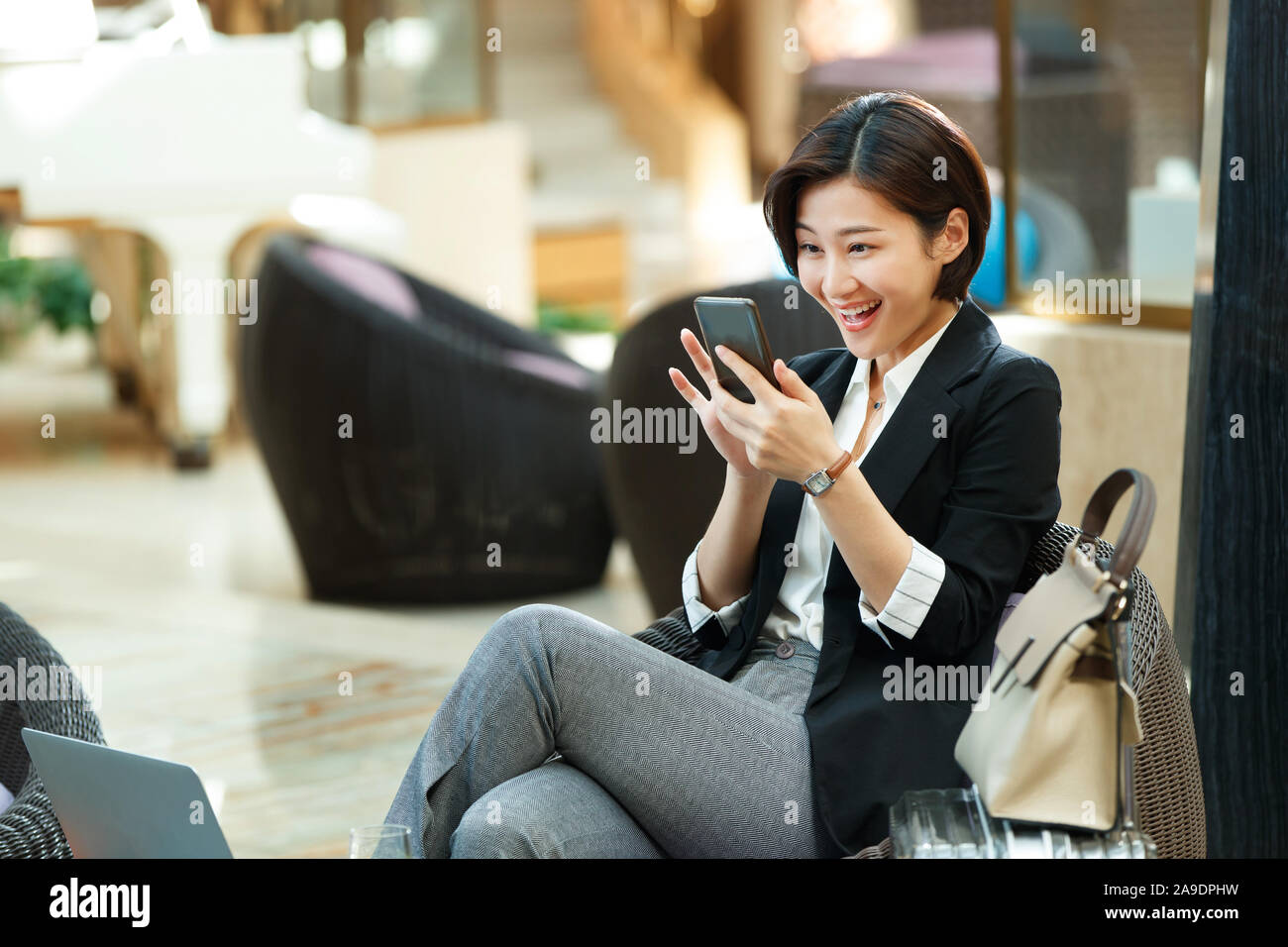 Lady using laptop at lobby hi-res stock photography and images - Alamy