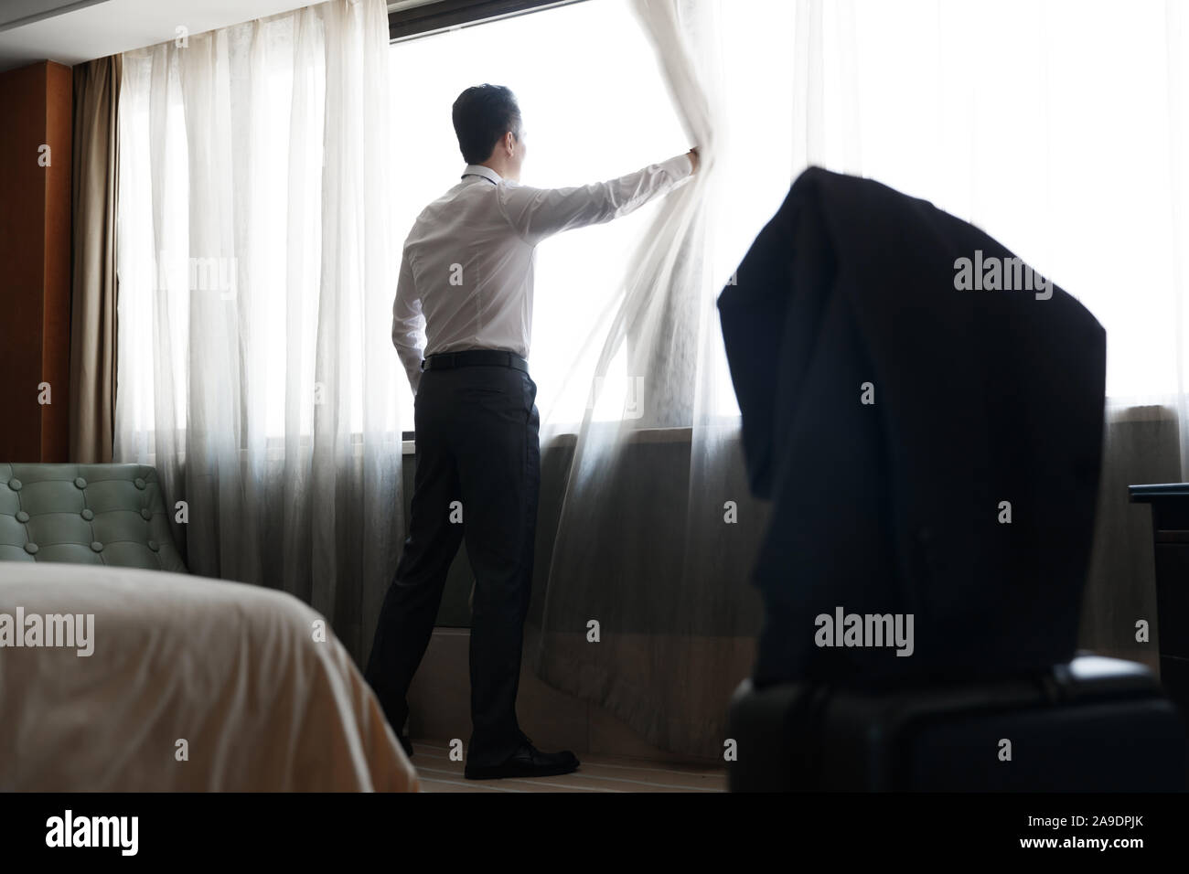 The young man standing in a hotel room Stock Photo - Alamy