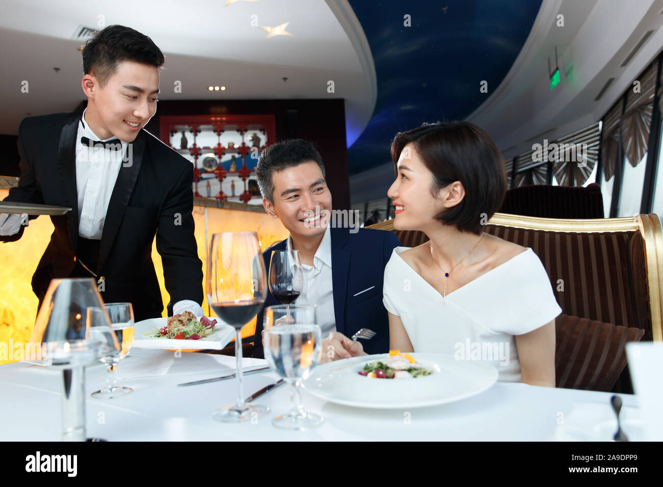 The hotel waiter serving for the customer Stock Photo - Alamy