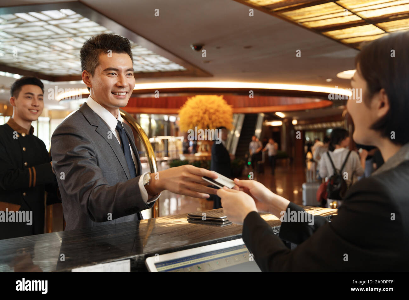 Business man for hotel registration Stock Photo - Alamy