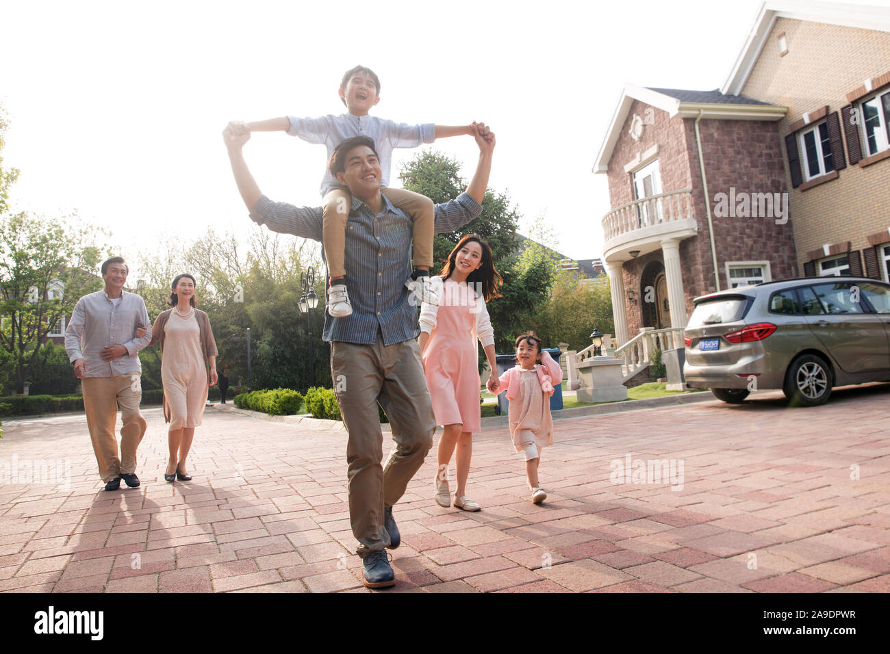 Happy family in the neighborhood for a walk Stock Photo - Alamy