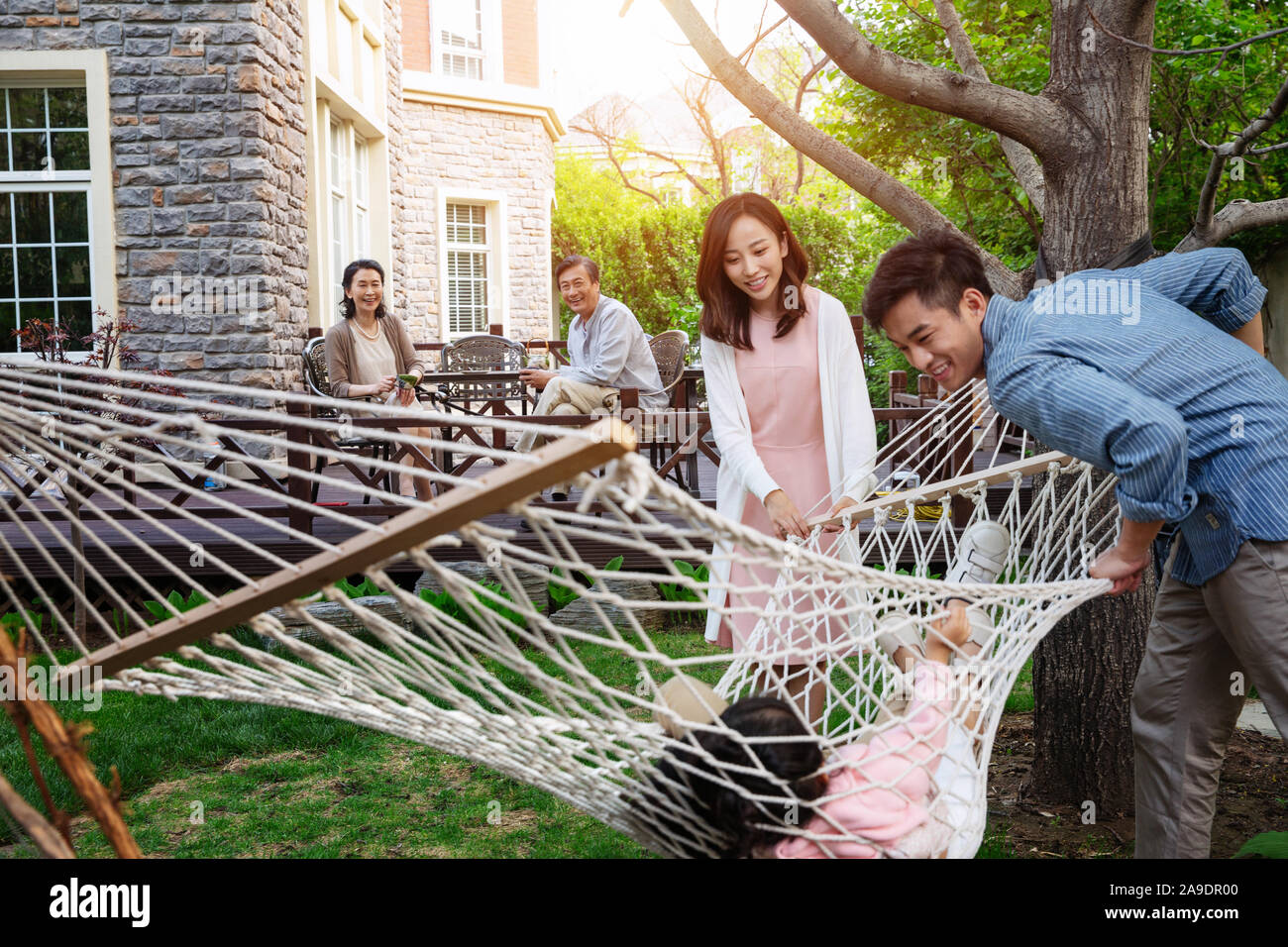 Happy family playing in the courtyard Stock Photo - Alamy