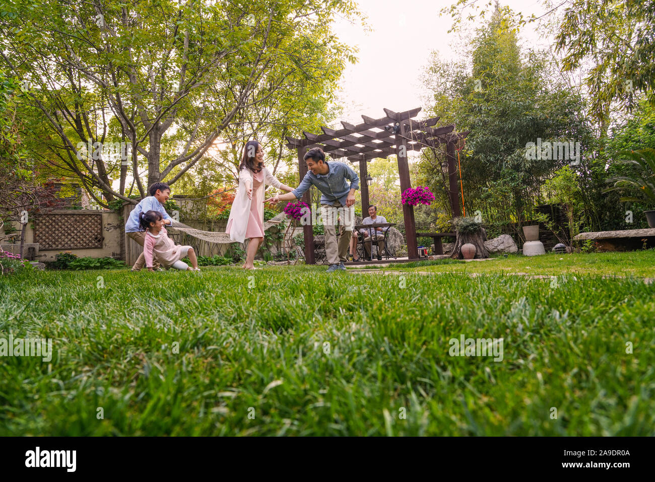 Happy family playing in the courtyard Stock Photo - Alamy