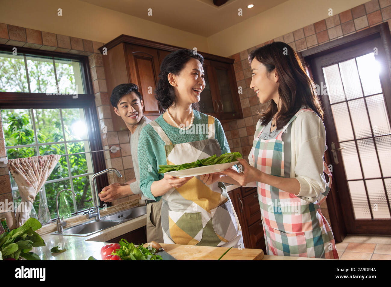 A happy family is cooking in the kitchen Stock Photo - Alamy