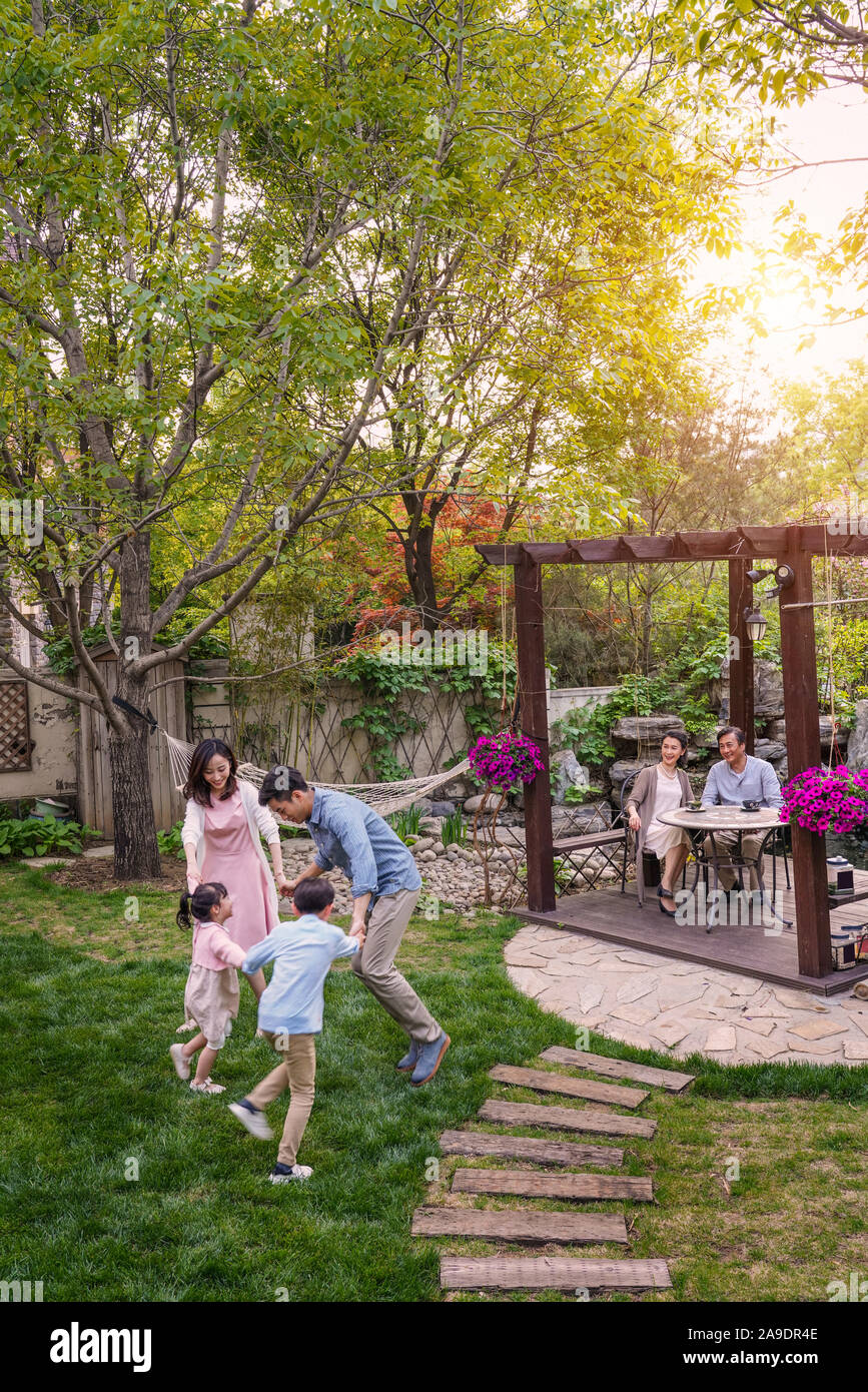 Happy family playing in the courtyard Stock Photo - Alamy