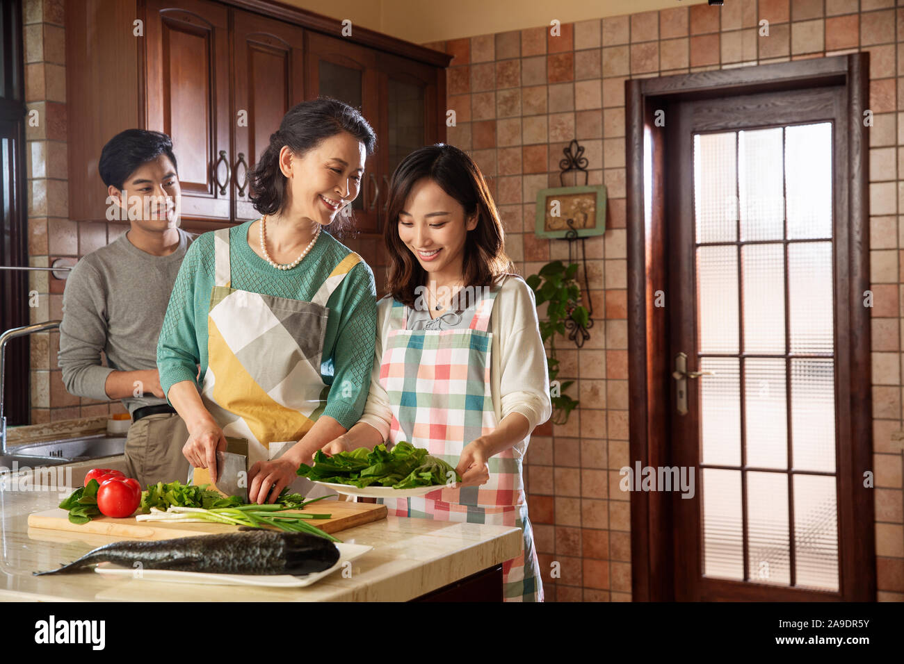 A happy family is cooking in the kitchen Stock Photo - Alamy