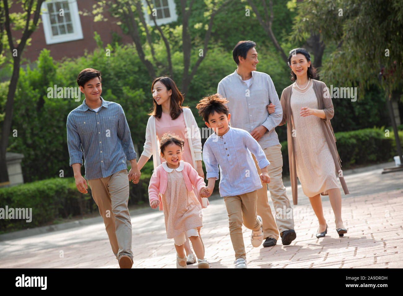 Happy family in the neighborhood for a walk Stock Photo - Alamy