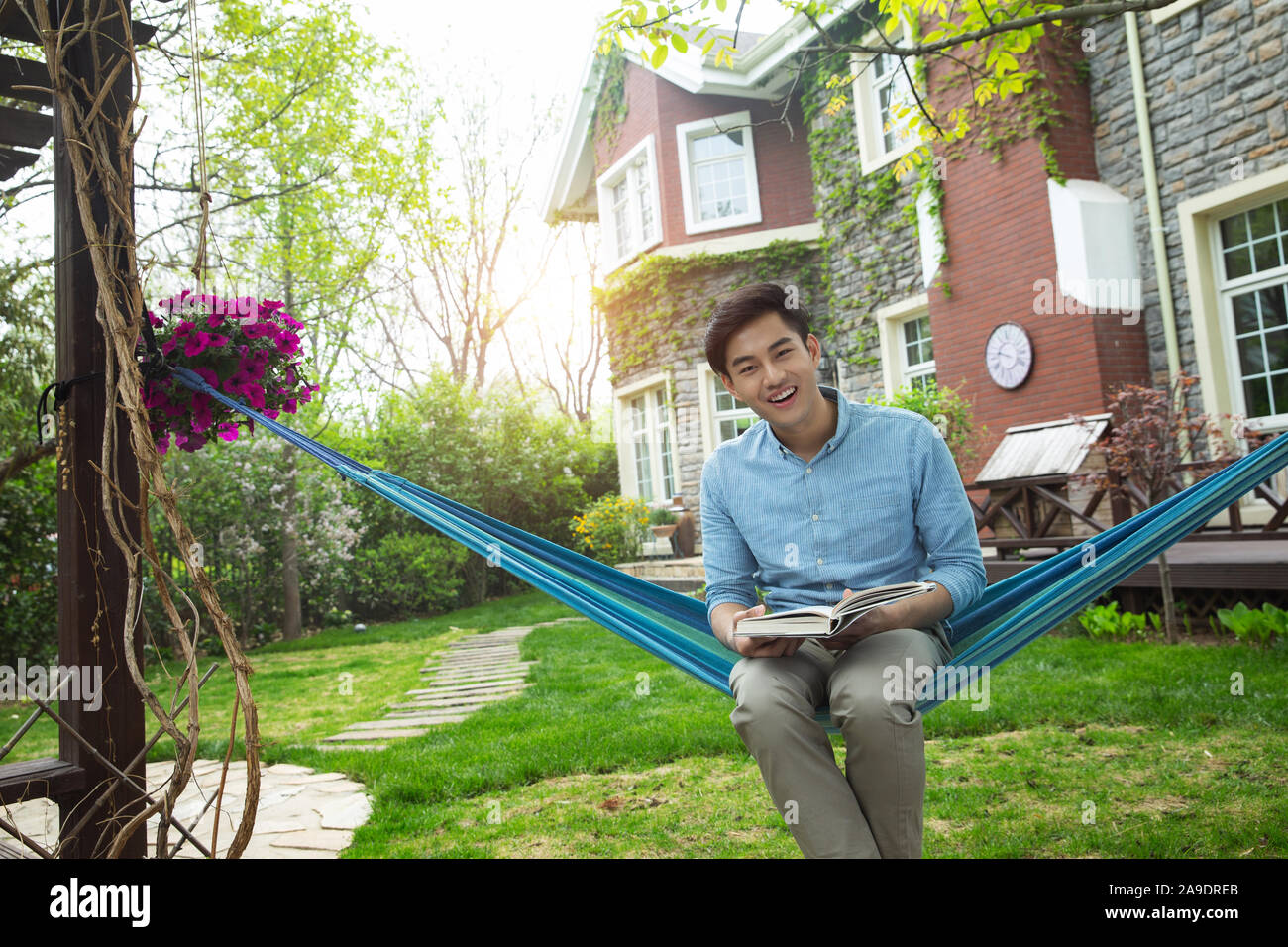 Young man reading in a courtyard hi-res stock photography and images ...
