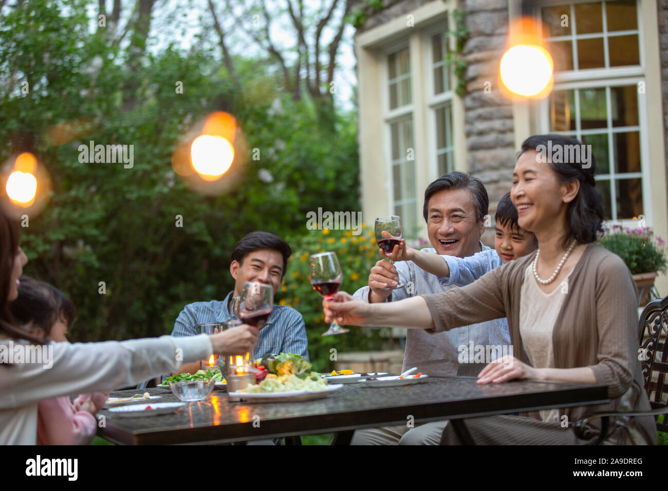 Happy family dinner in the garden Stock Photo - Alamy
