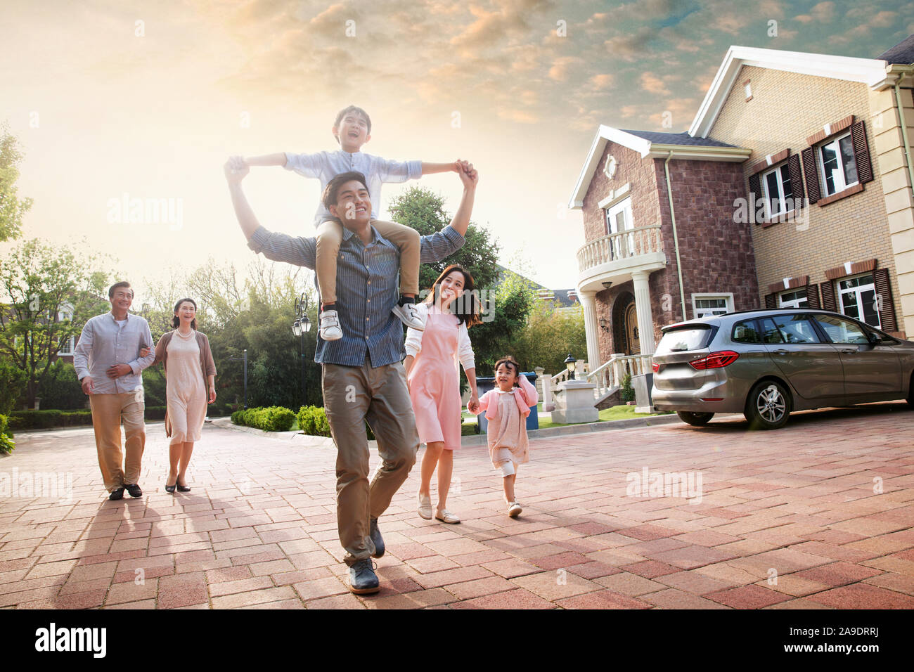 Happy family in the neighborhood for a walk Stock Photo - Alamy