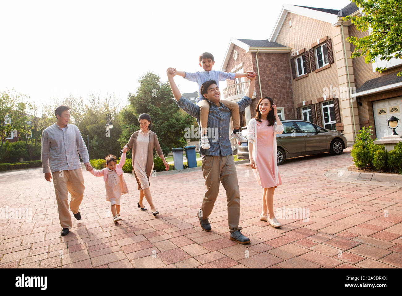 Happy family in the neighborhood for a walk Stock Photo - Alamy