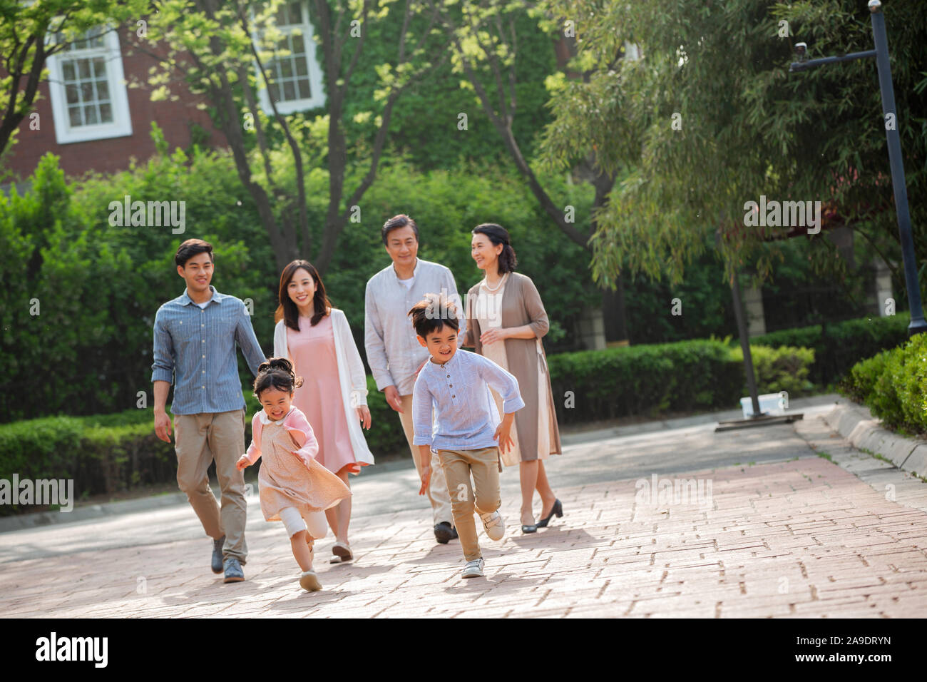 Happy family in the neighborhood for a walk Stock Photo - Alamy