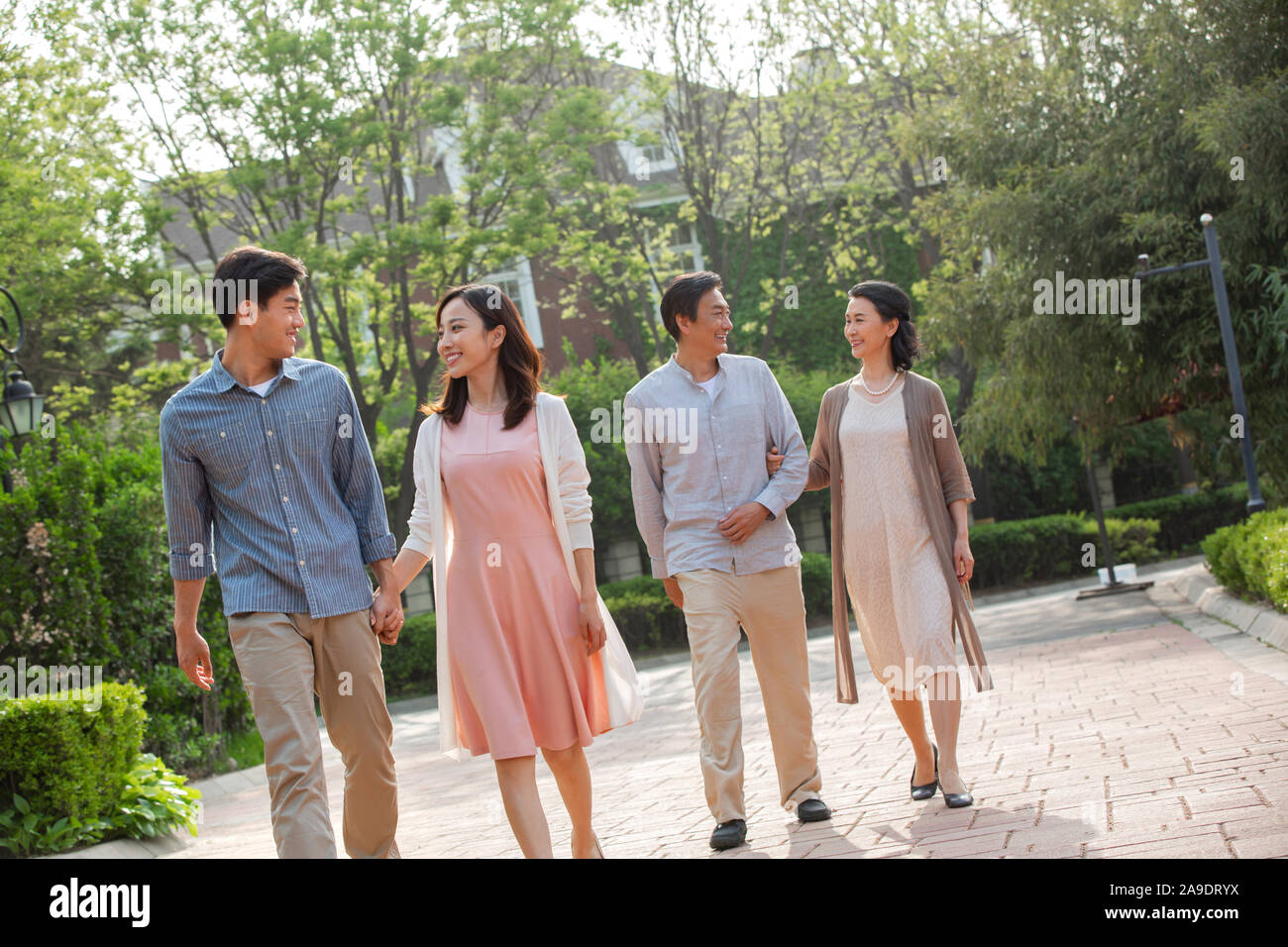 Happy family in the neighborhood for a walk Stock Photo - Alamy