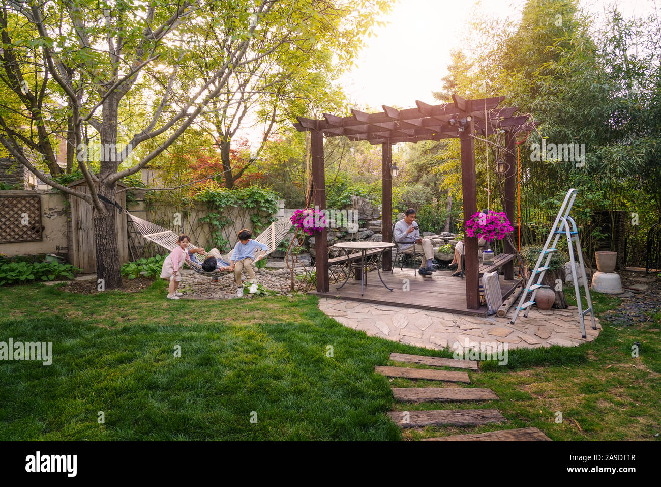 Happy family playing in the courtyard Stock Photo - Alamy