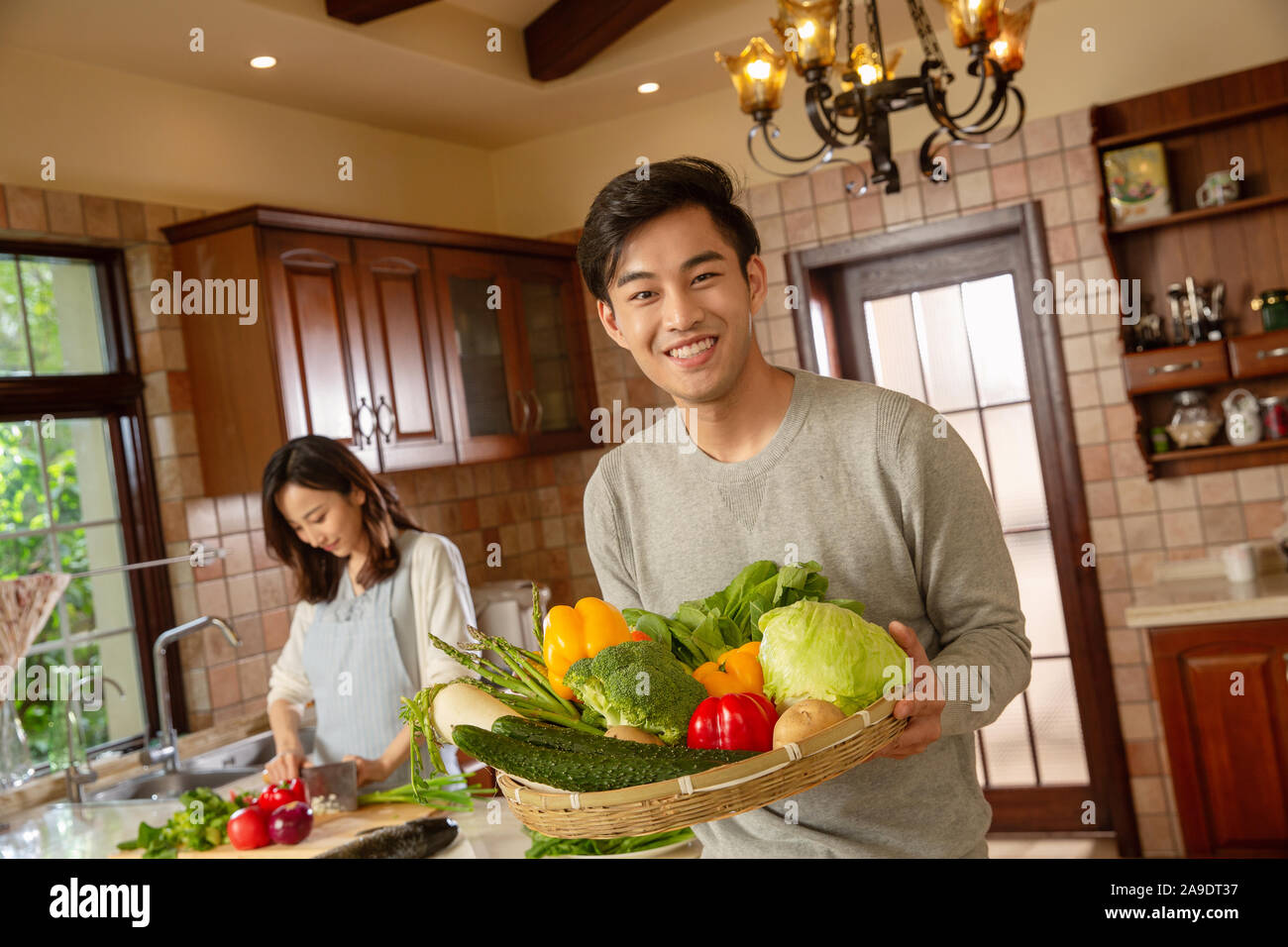 Young couples in cooking in the kitchen Stock Photo - Alamy