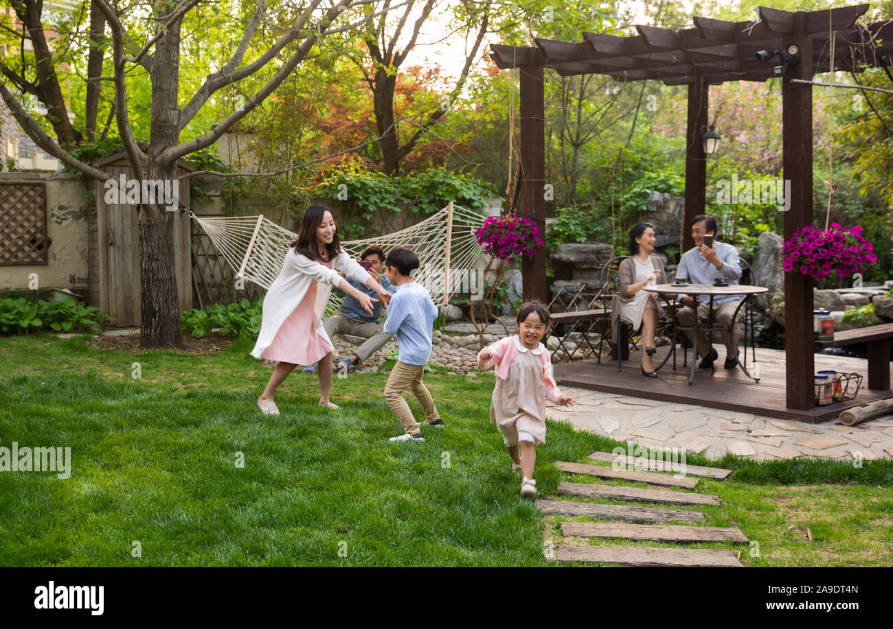 Happy family playing in the courtyard Stock Photo - Alamy