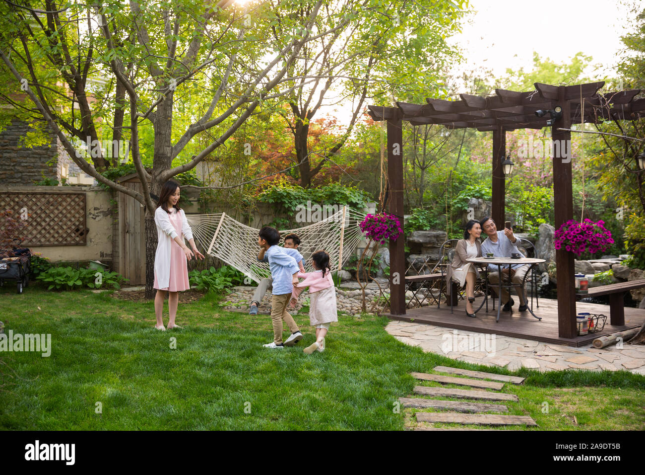 Happy family playing in the courtyard Stock Photo - Alamy