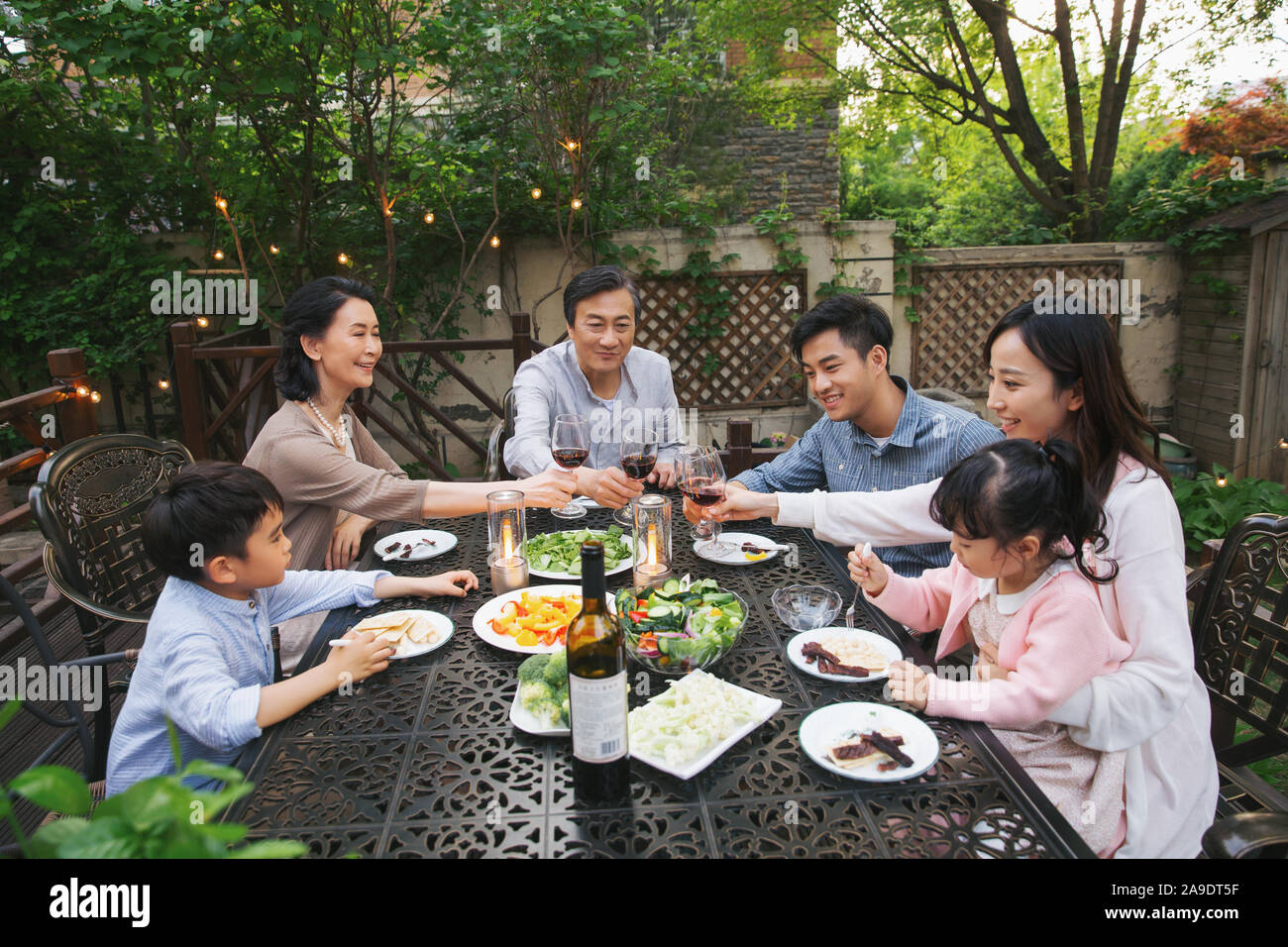 Happy family dinner in the garden Stock Photo - Alamy