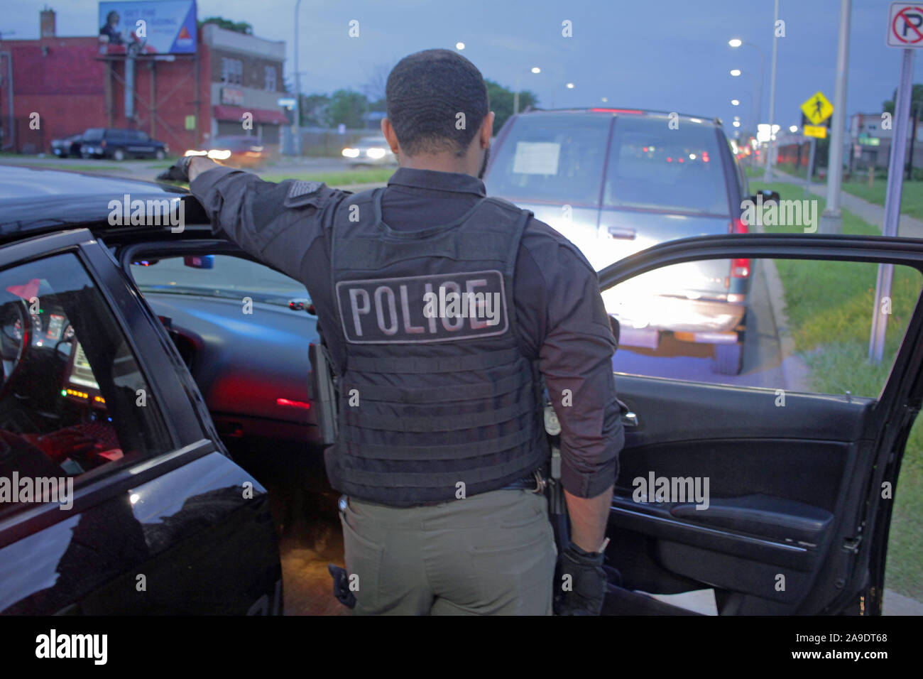 Detroit police officer checks a van in Detroit, Michigan, USA Stock ...