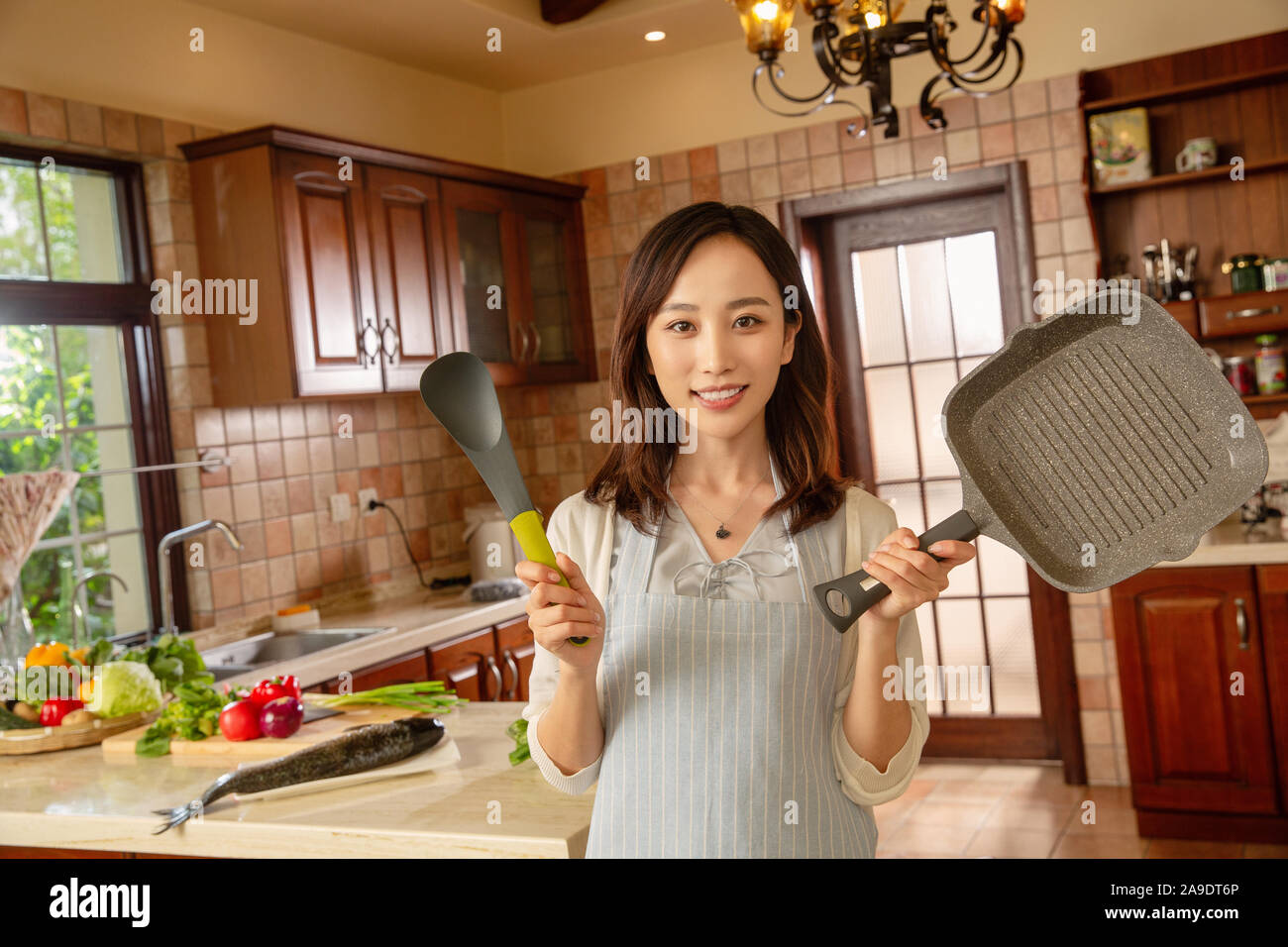 Woman cooking at home in china hi-res stock photography and images - Alamy