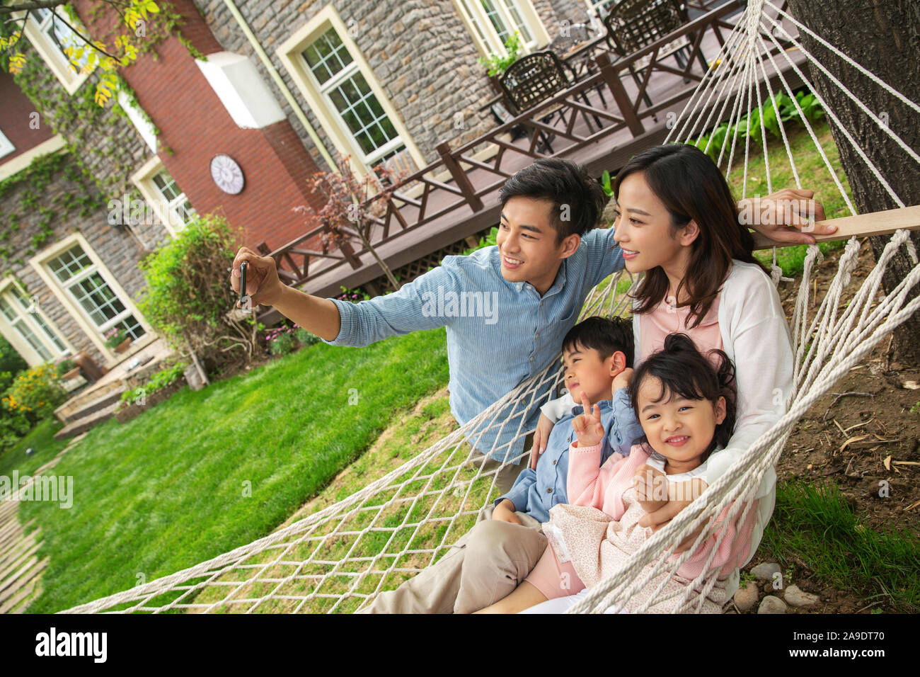 Happy family photographs in the yard Stock Photo - Alamy