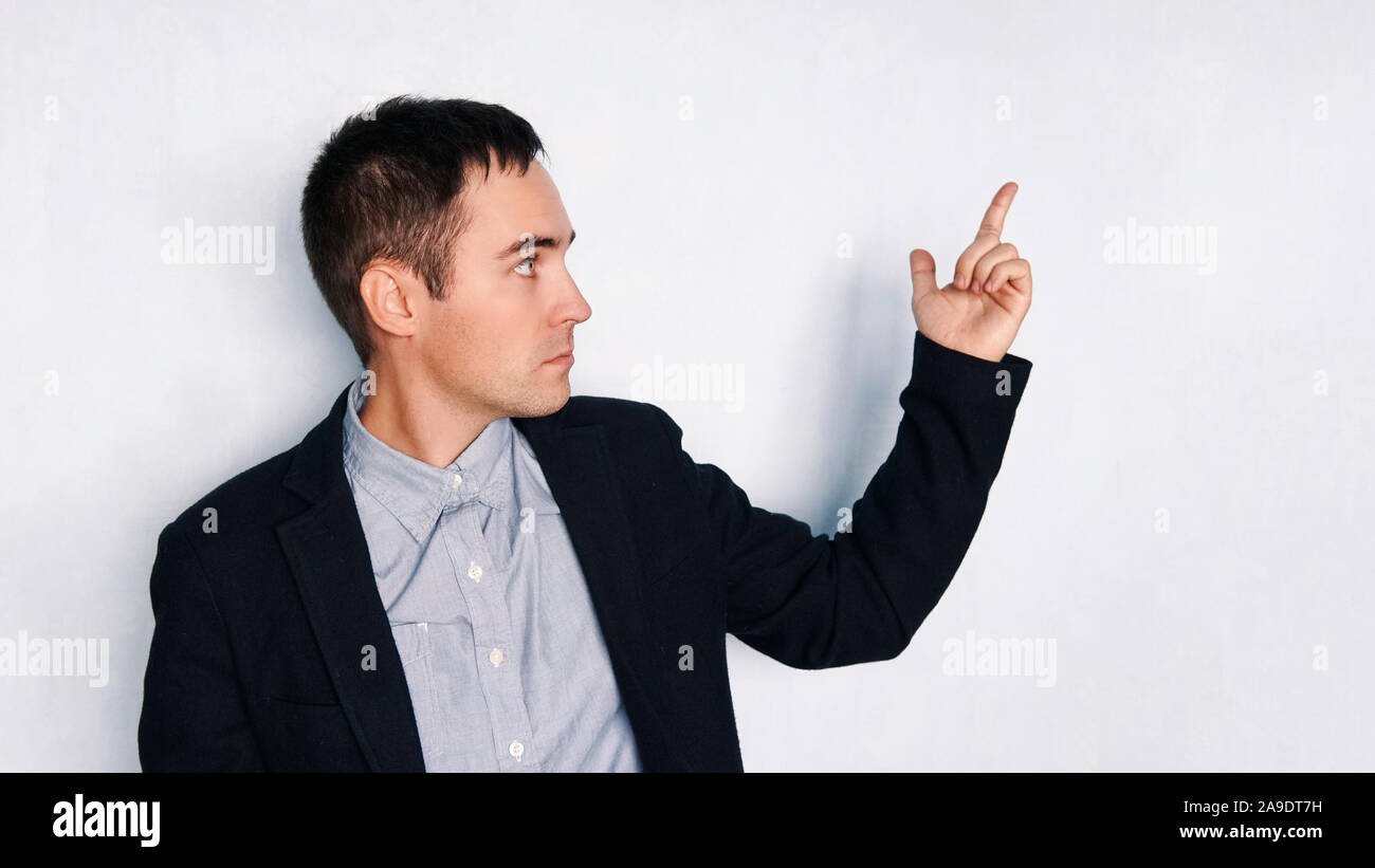 business man points with fingers in the right side. A young man in a ...