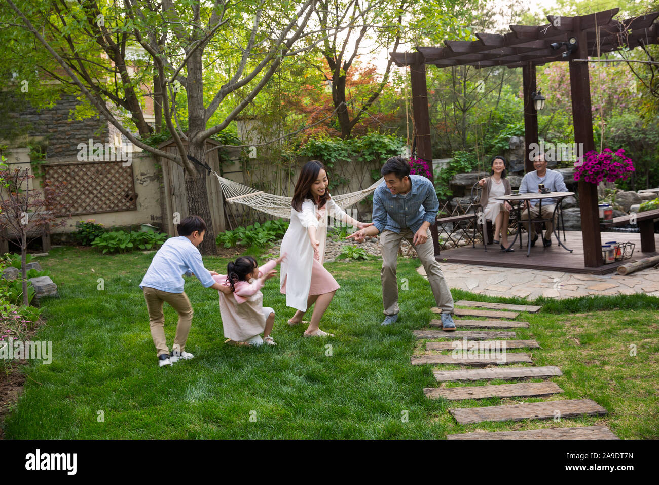 Happy family playing in the courtyard Stock Photo - Alamy