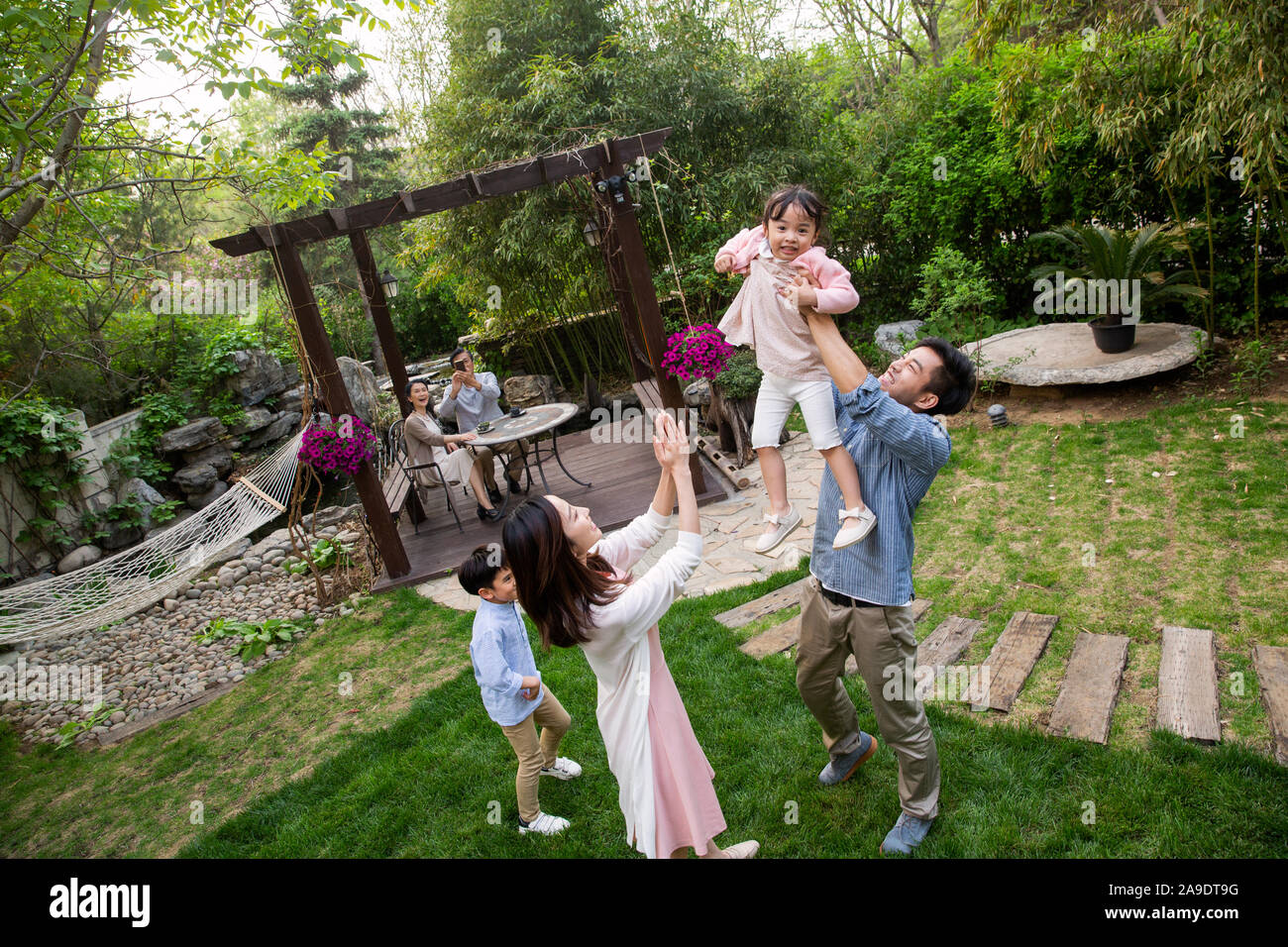 Happy family playing in the courtyard Stock Photo - Alamy