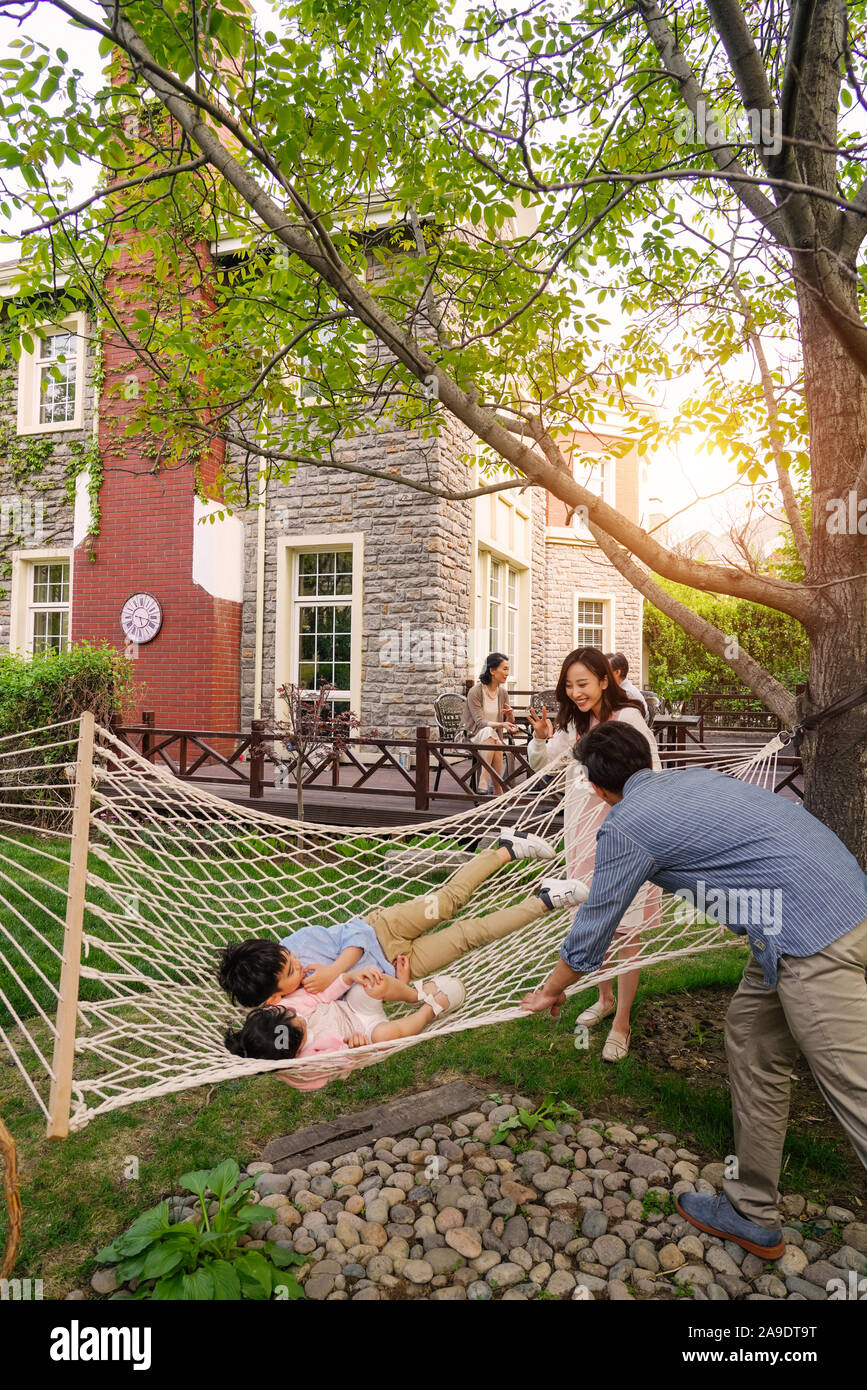 Happy family playing in the courtyard Stock Photo - Alamy