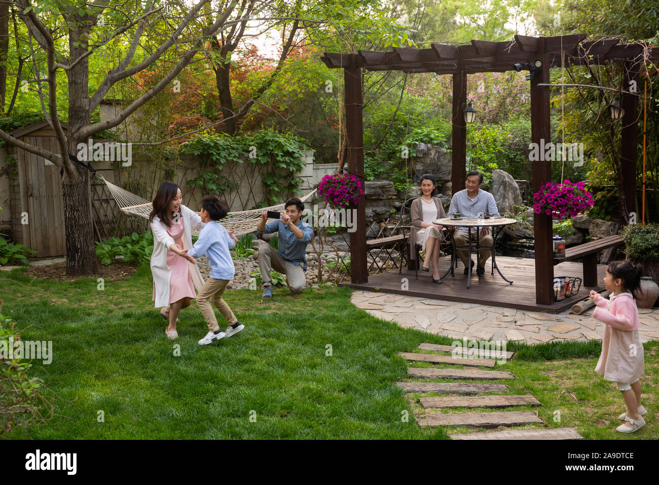 Happy family playing in the courtyard Stock Photo - Alamy