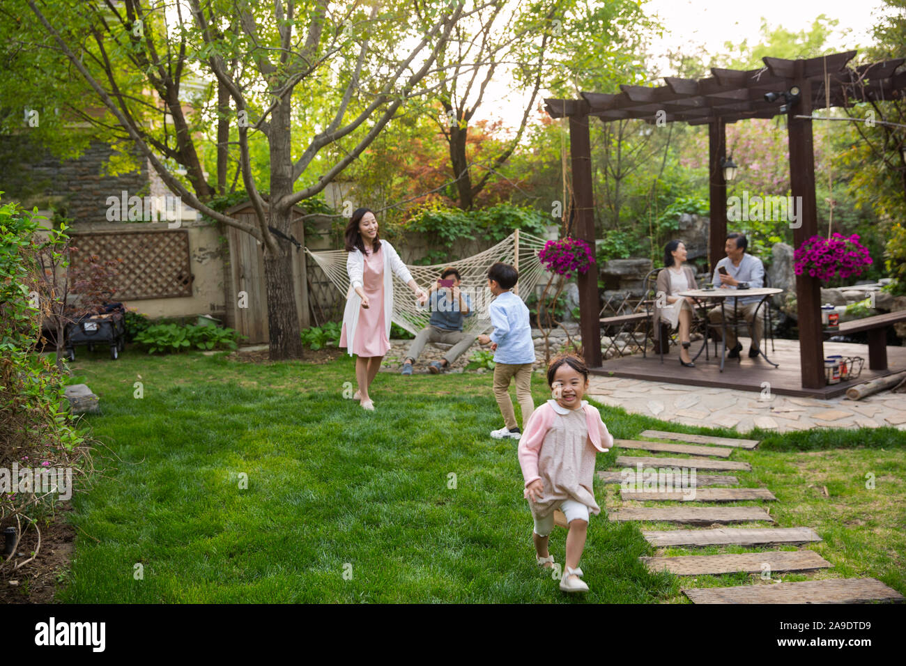 Happy family playing in the courtyard Stock Photo - Alamy