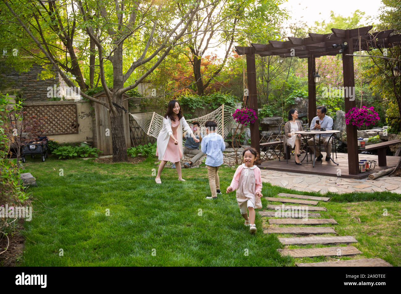 Happy family playing in the courtyard Stock Photo - Alamy