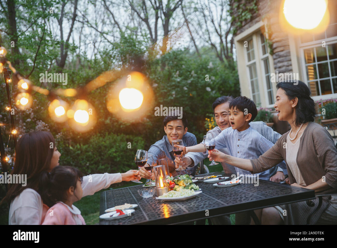 Happy family dinner in the garden Stock Photo - Alamy
