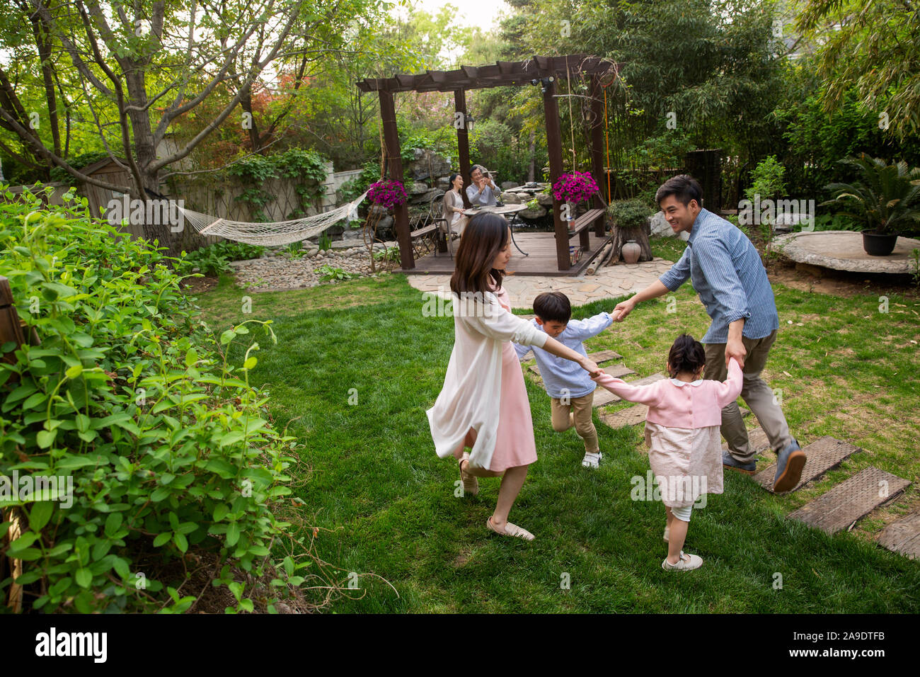 Happy family playing in the courtyard Stock Photo - Alamy