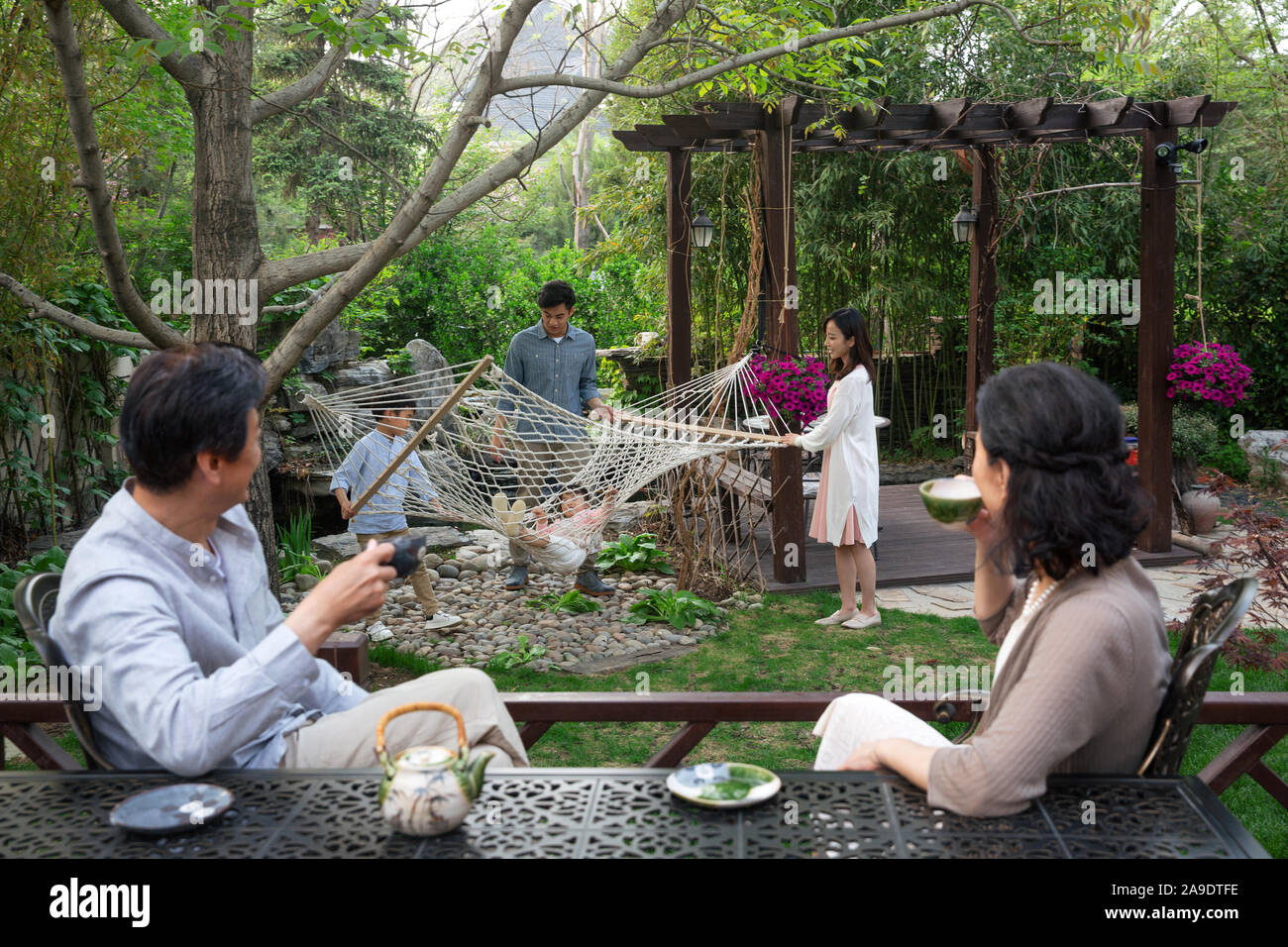 Happy family playing in the courtyard Stock Photo - Alamy
