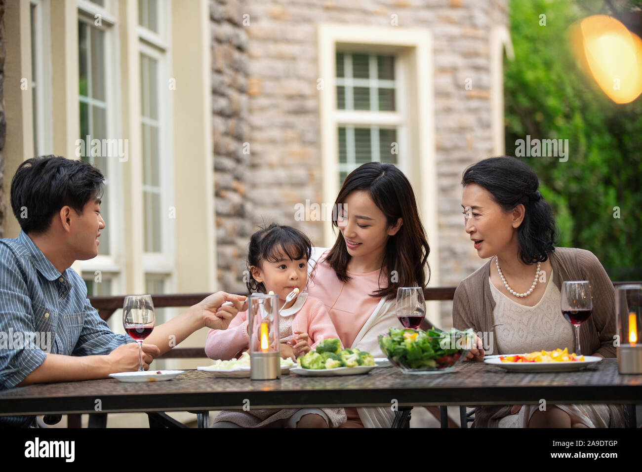 Happy family dinner in the garden Stock Photo - Alamy