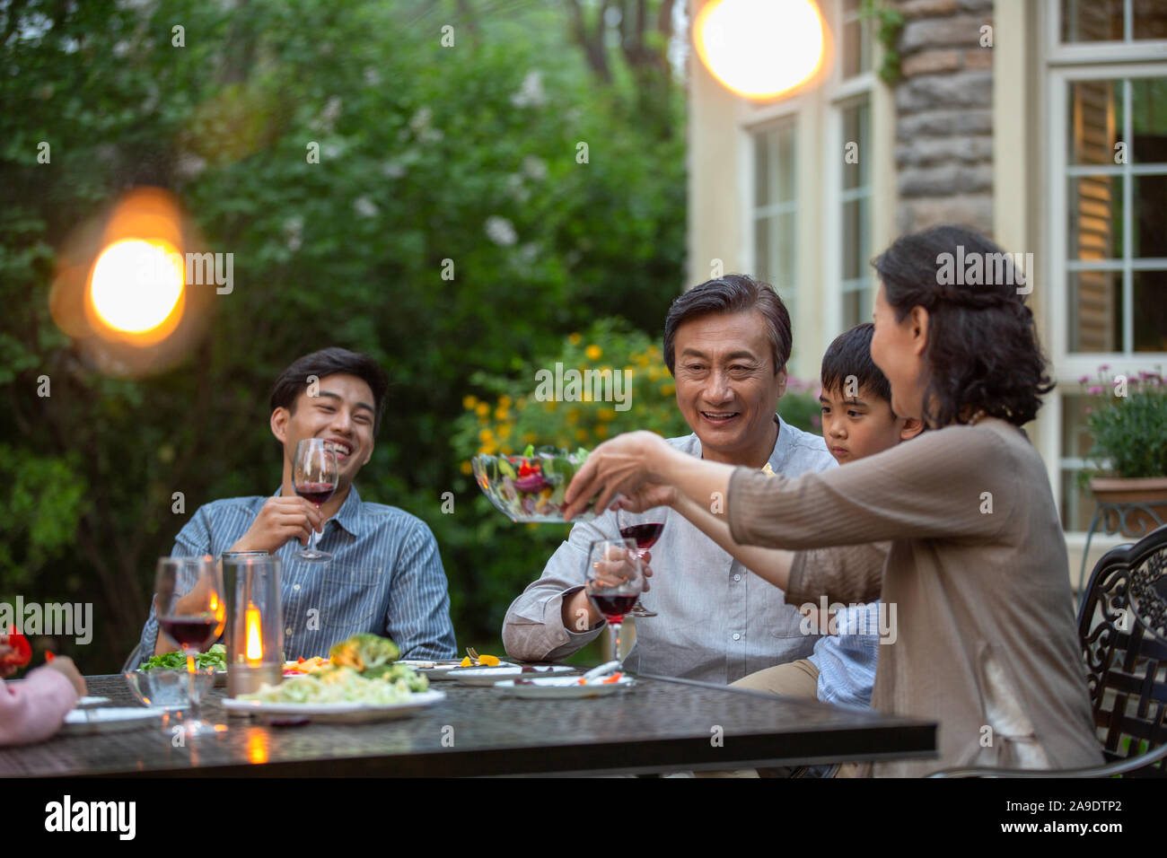 Happy family dinner in the garden Stock Photo - Alamy