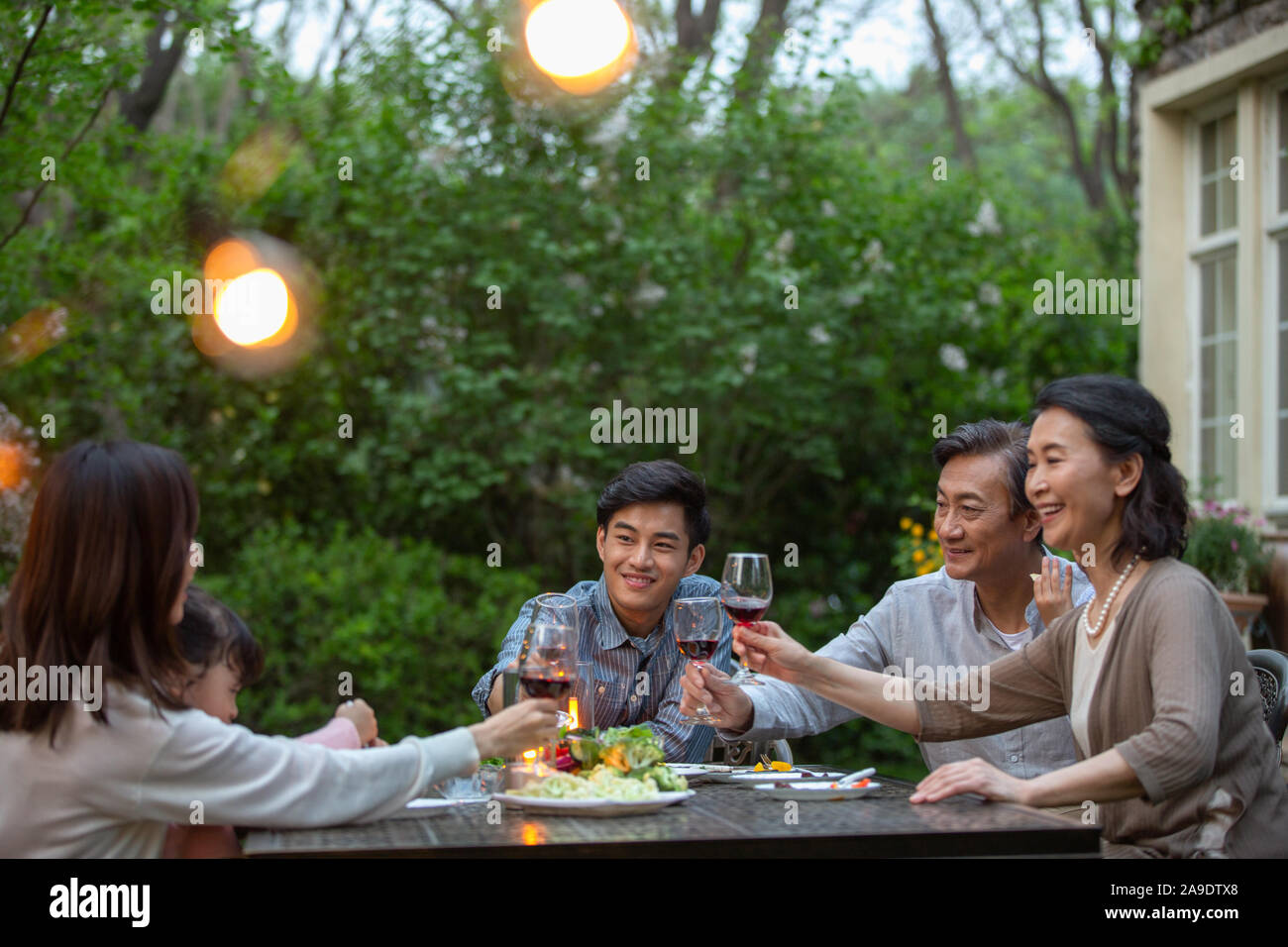 Happy family dinner in the garden Stock Photo - Alamy