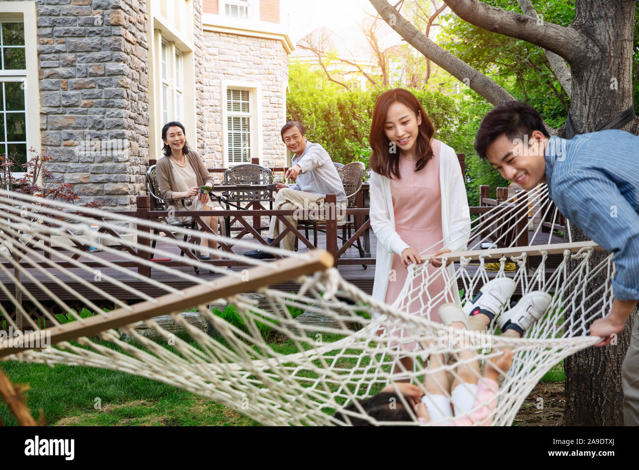 Happy family playing in the courtyard Stock Photo - Alamy