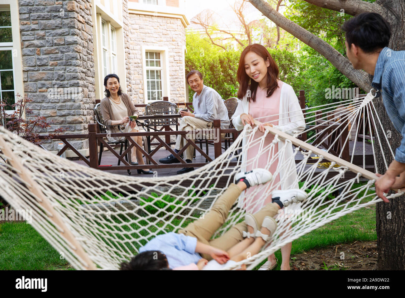Happy family playing in the courtyard Stock Photo - Alamy