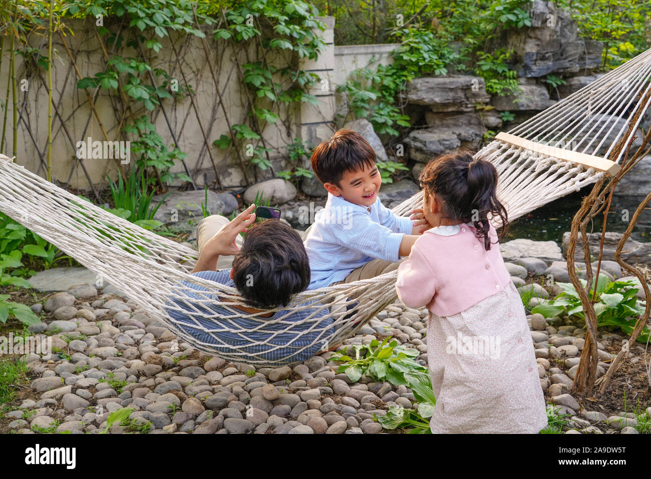 Father and children playing in the yard Stock Photo - Alamy
